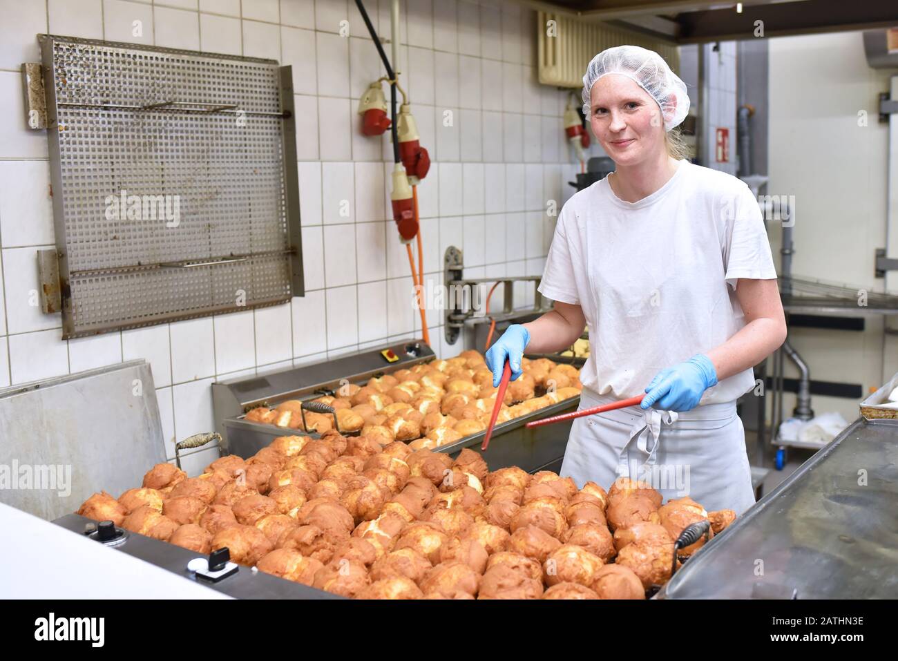 female Worker in a large bakery - industrial production of bakery ...