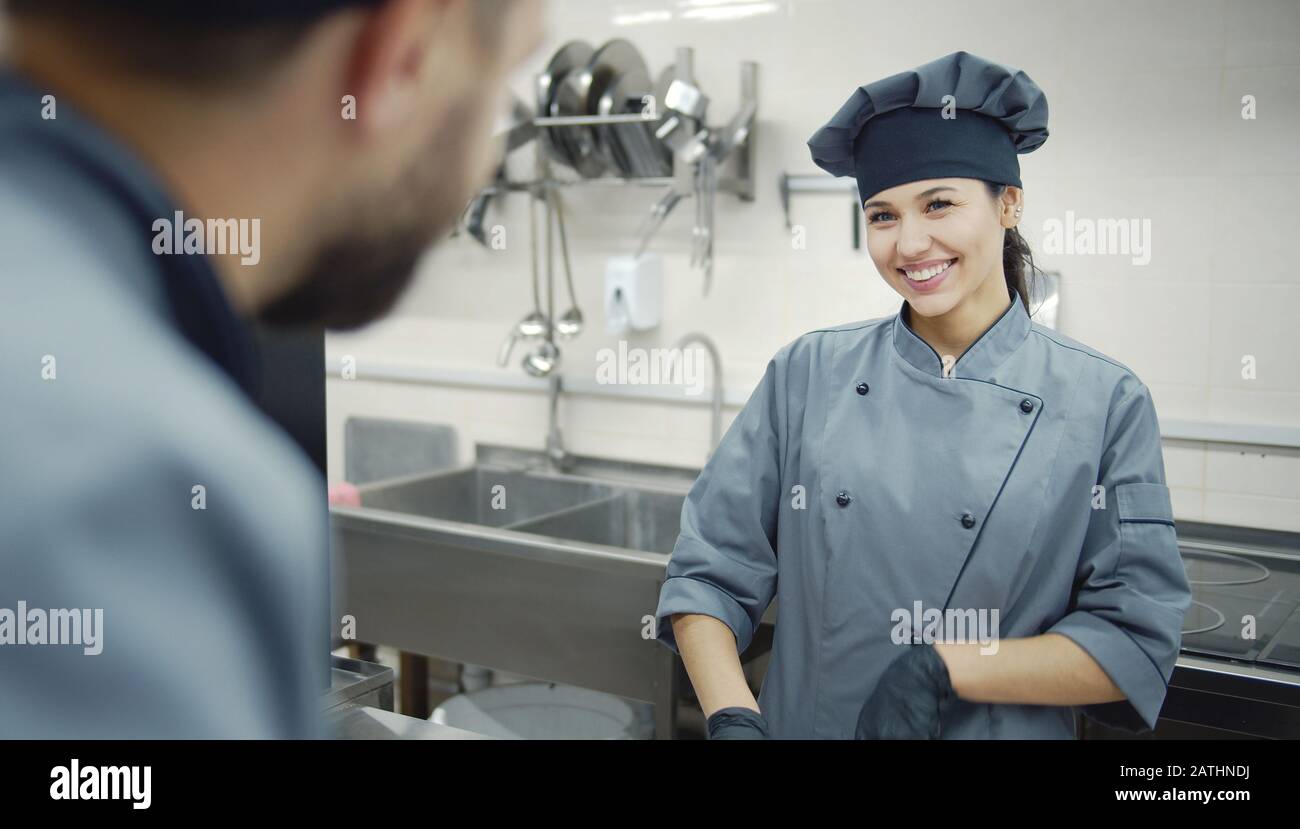 Two chefs talking while cooking Stock Photo - Alamy