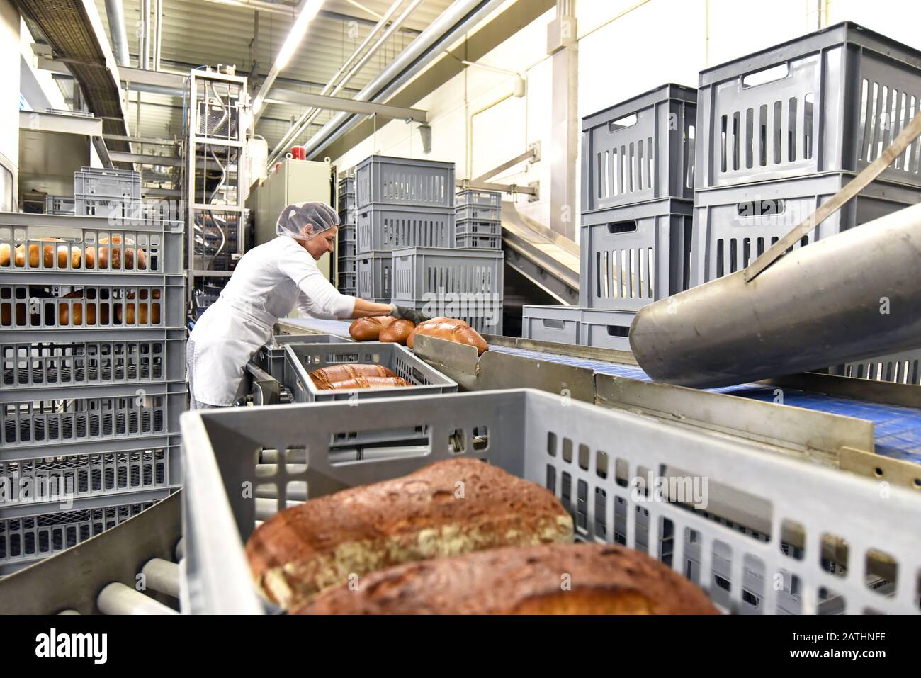 woman working in a large bakery - industrial production of bakery ...