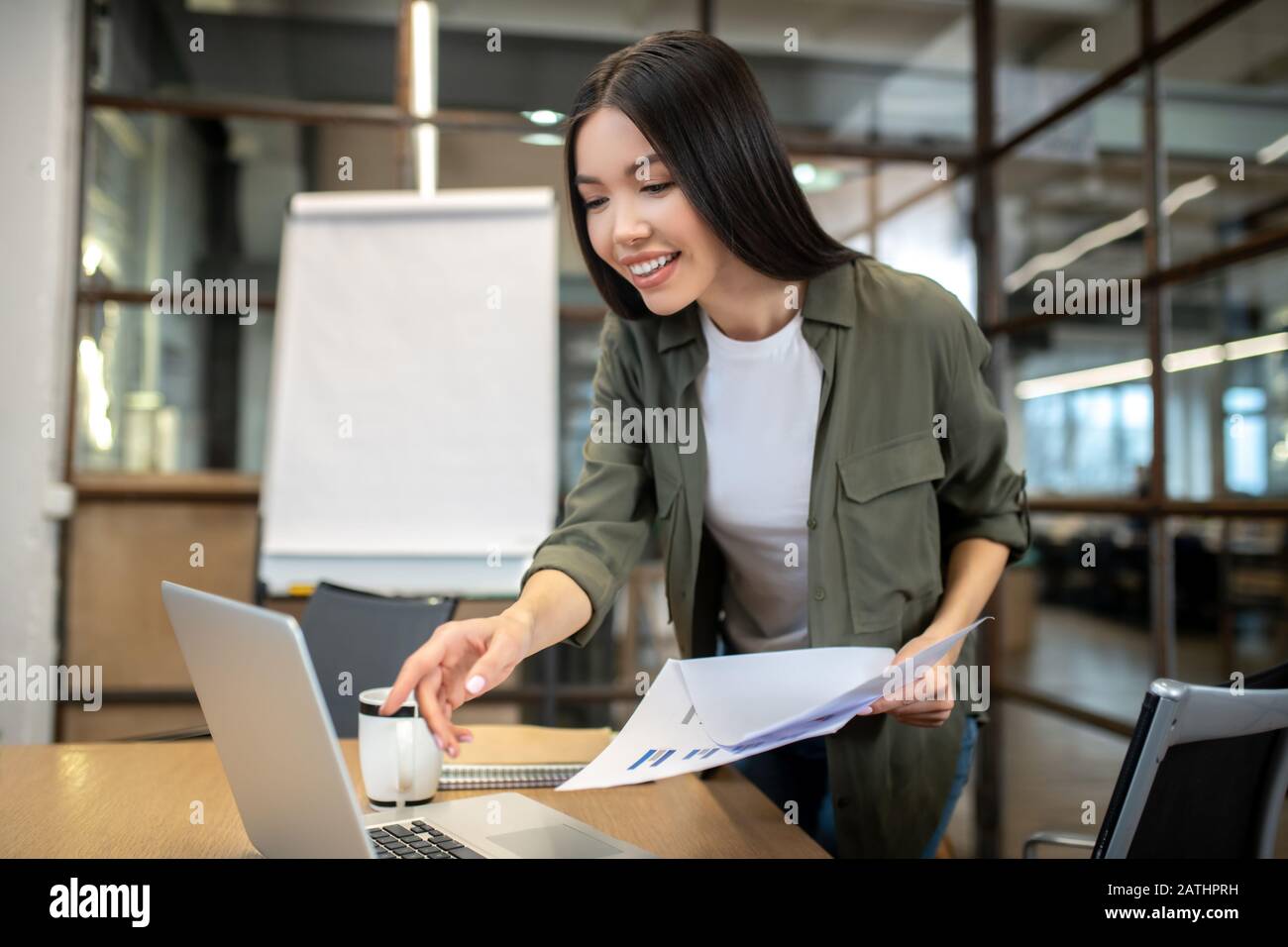 Long-haired brunette asian girl dealing with documents Stock Photo - Alamy