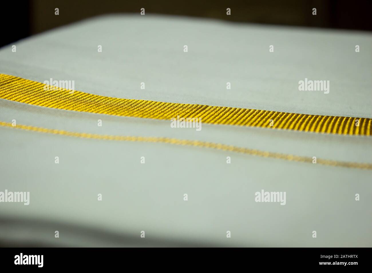 Close view of the dhoti with gold threaded border. Dhoti is a ...