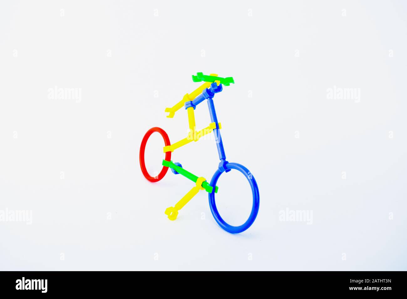 Front view of a bicycle made of plastic shape shifting toy on a white ...