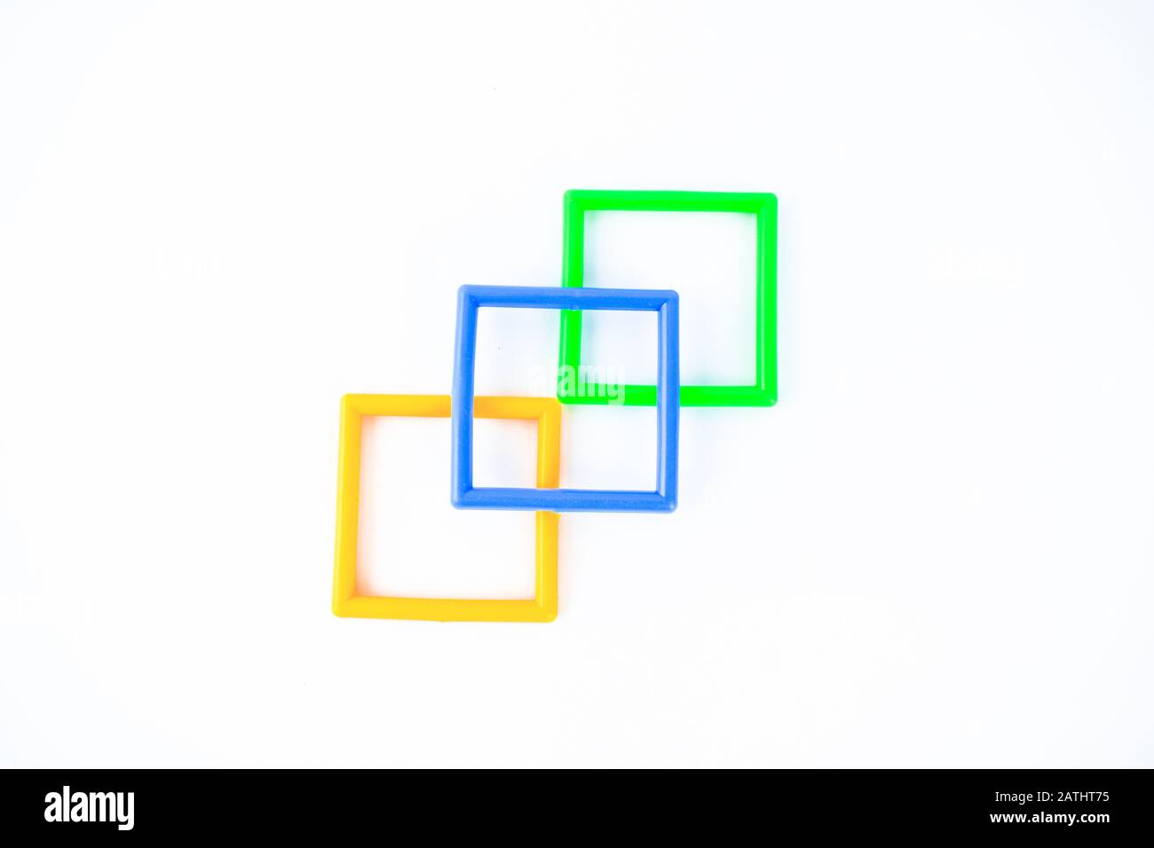 Three square shaped plastic toys with different color isolated on a ...