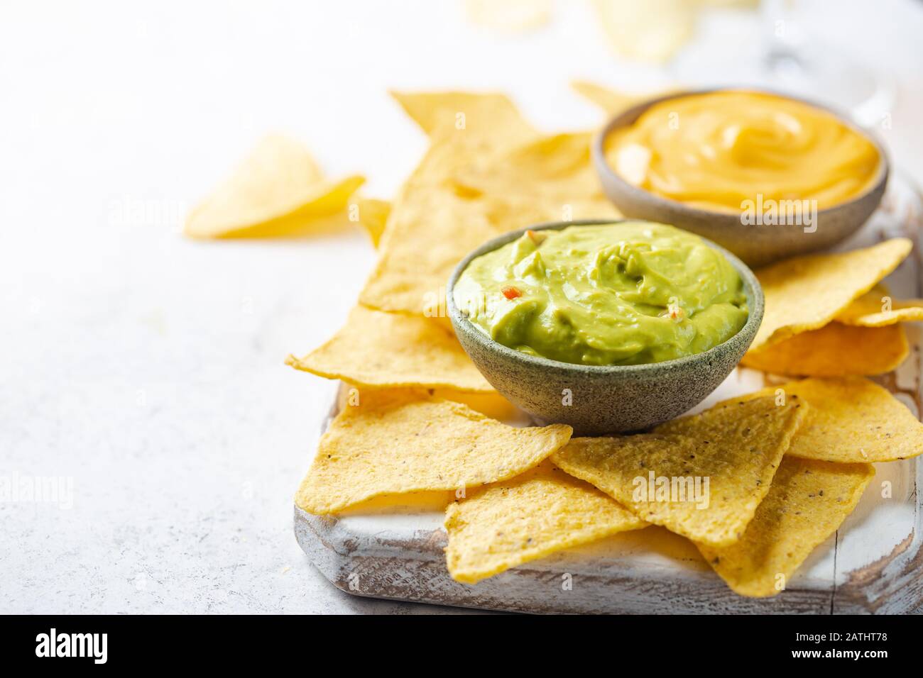 Nachos chips in a bowl with sauces guacamole and cheese, dip variety ...