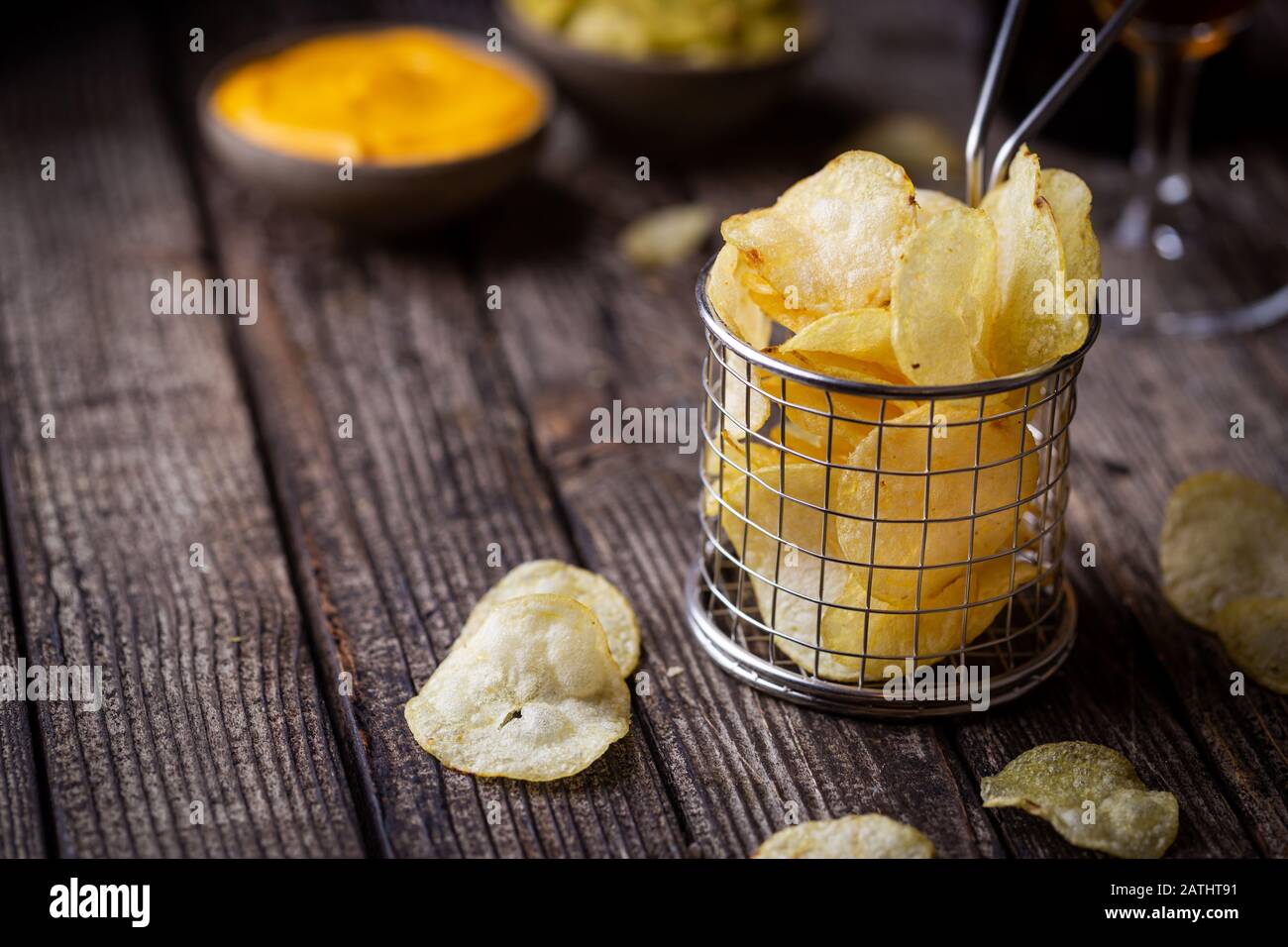 Crunchy delicious potato chips for a tasty snack break on dark rustic ...