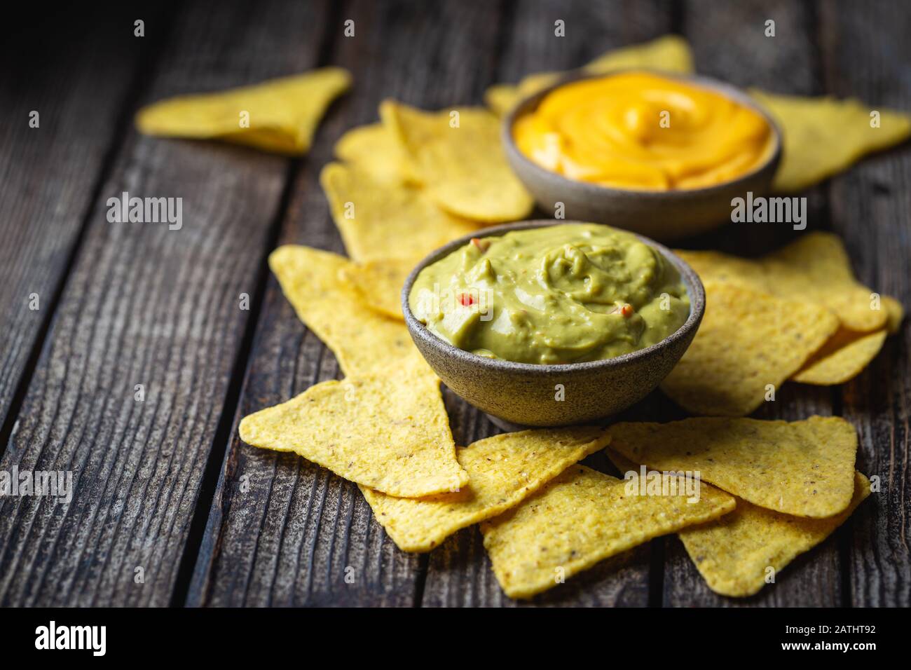 Nachos chips in a bowl with sauces guacamole and cheese, dip variety ...