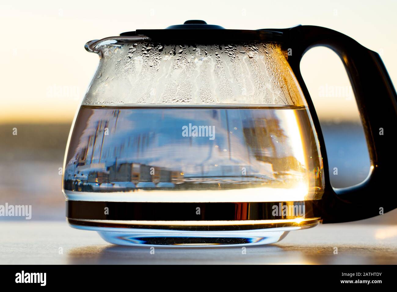 A jug of water for tea. A teapot made of transparent glass with hot ...