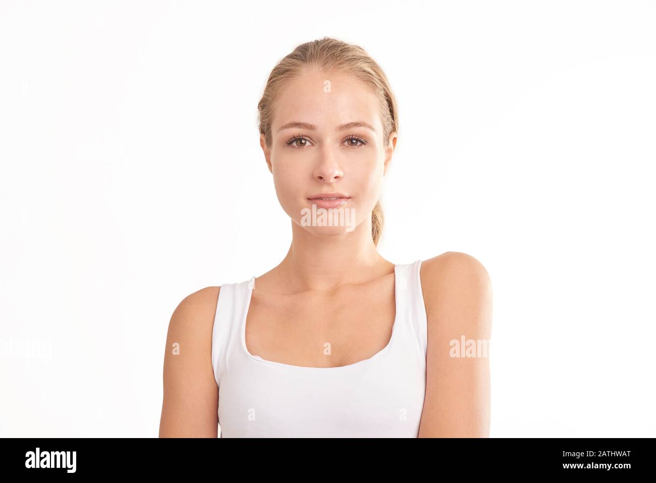 Portrait shot of young woman with beautiful face looking at camera and ...