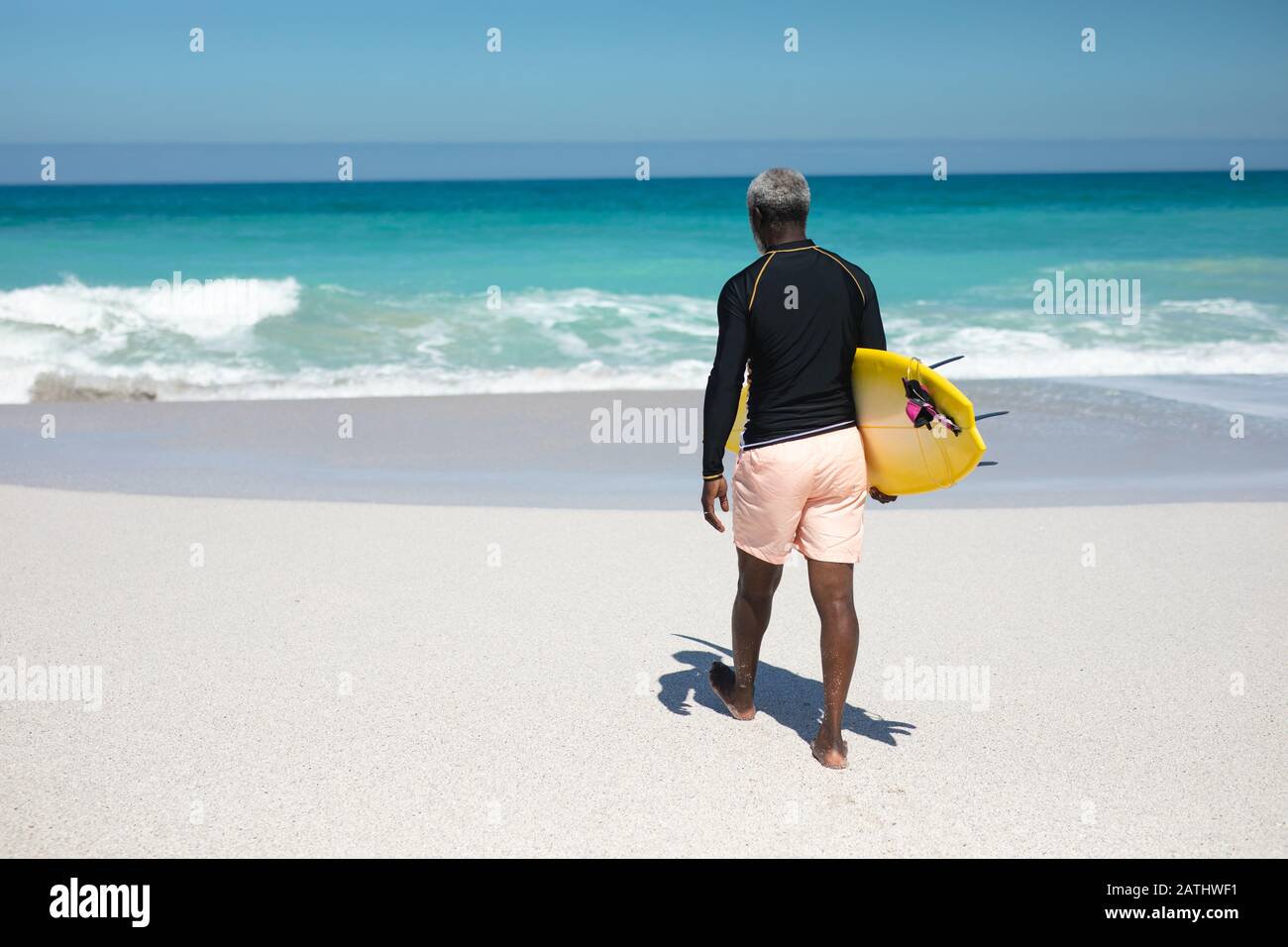 Man carrying surfboard water hi-res stock photography and images - Alamy