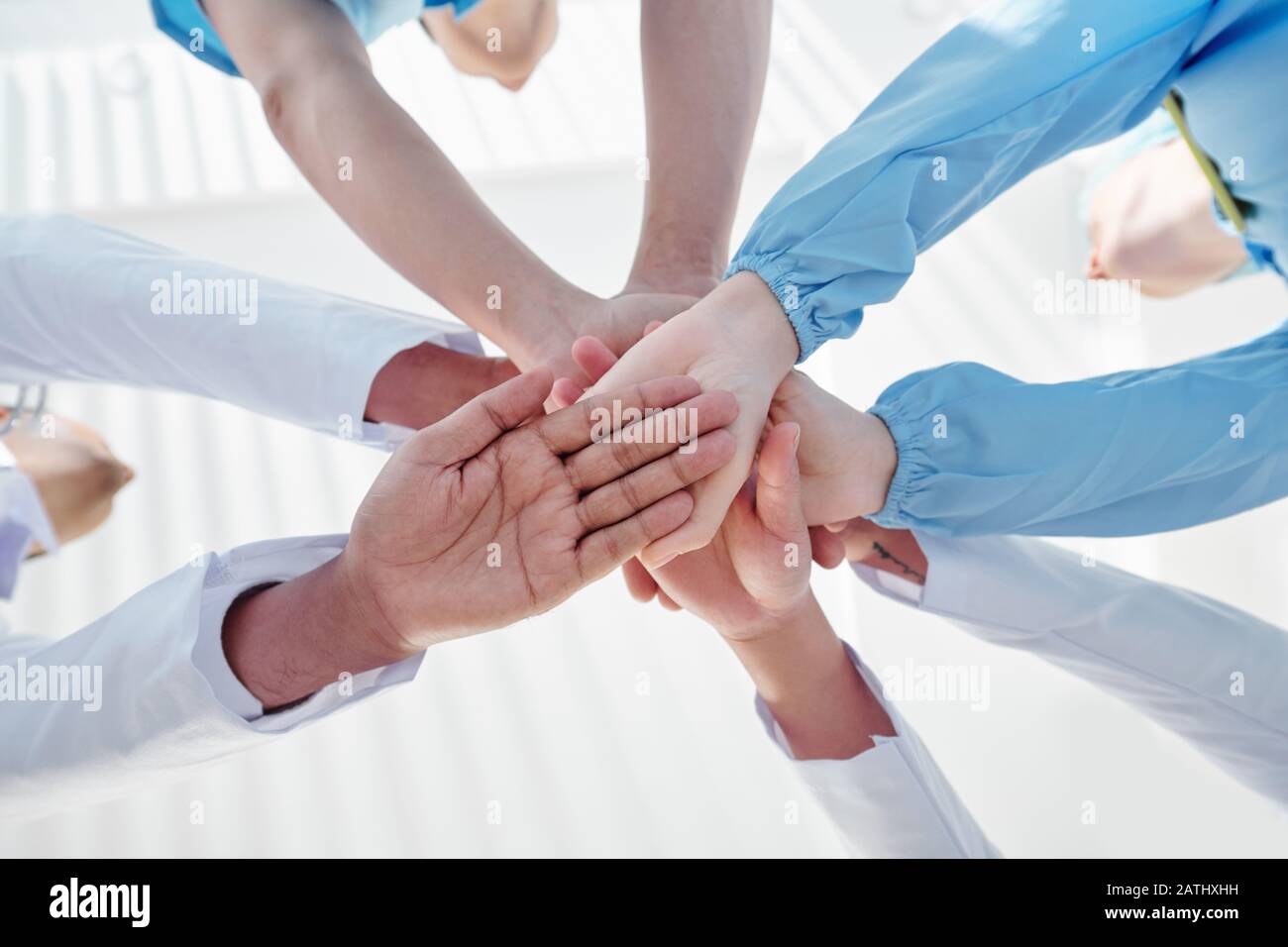 Medical workers stacking hands to express unity, view from below Stock ...
