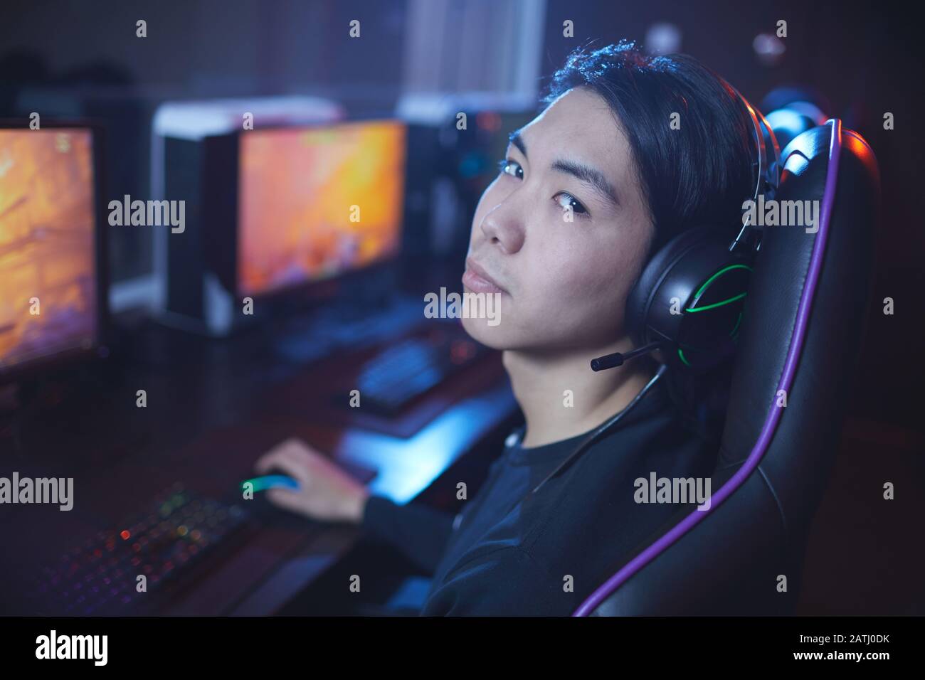 High angle portrait of young Asian man looking up at camera while ...