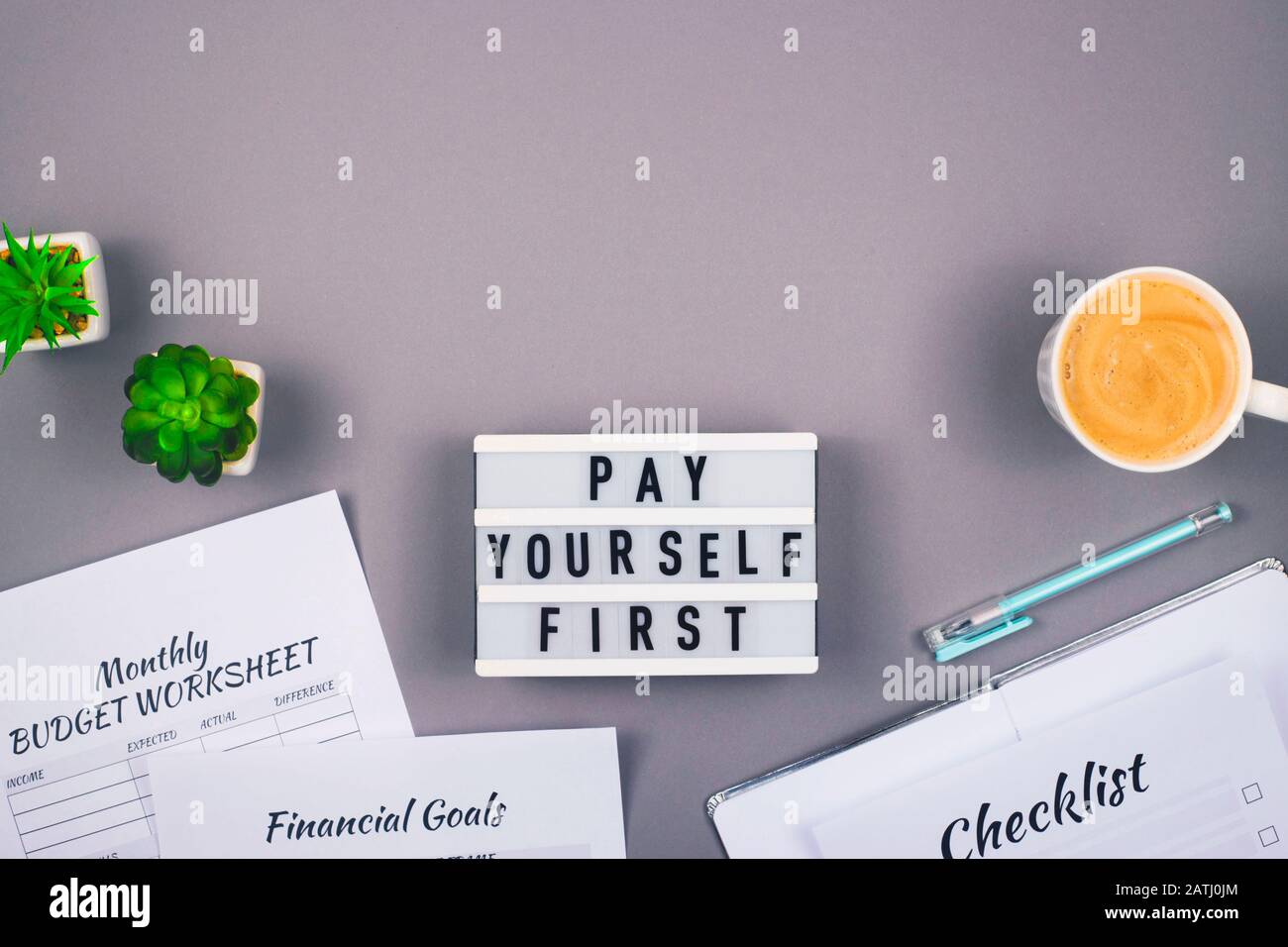 Pay yourself first. It is written on a decorative panel on the gray ...