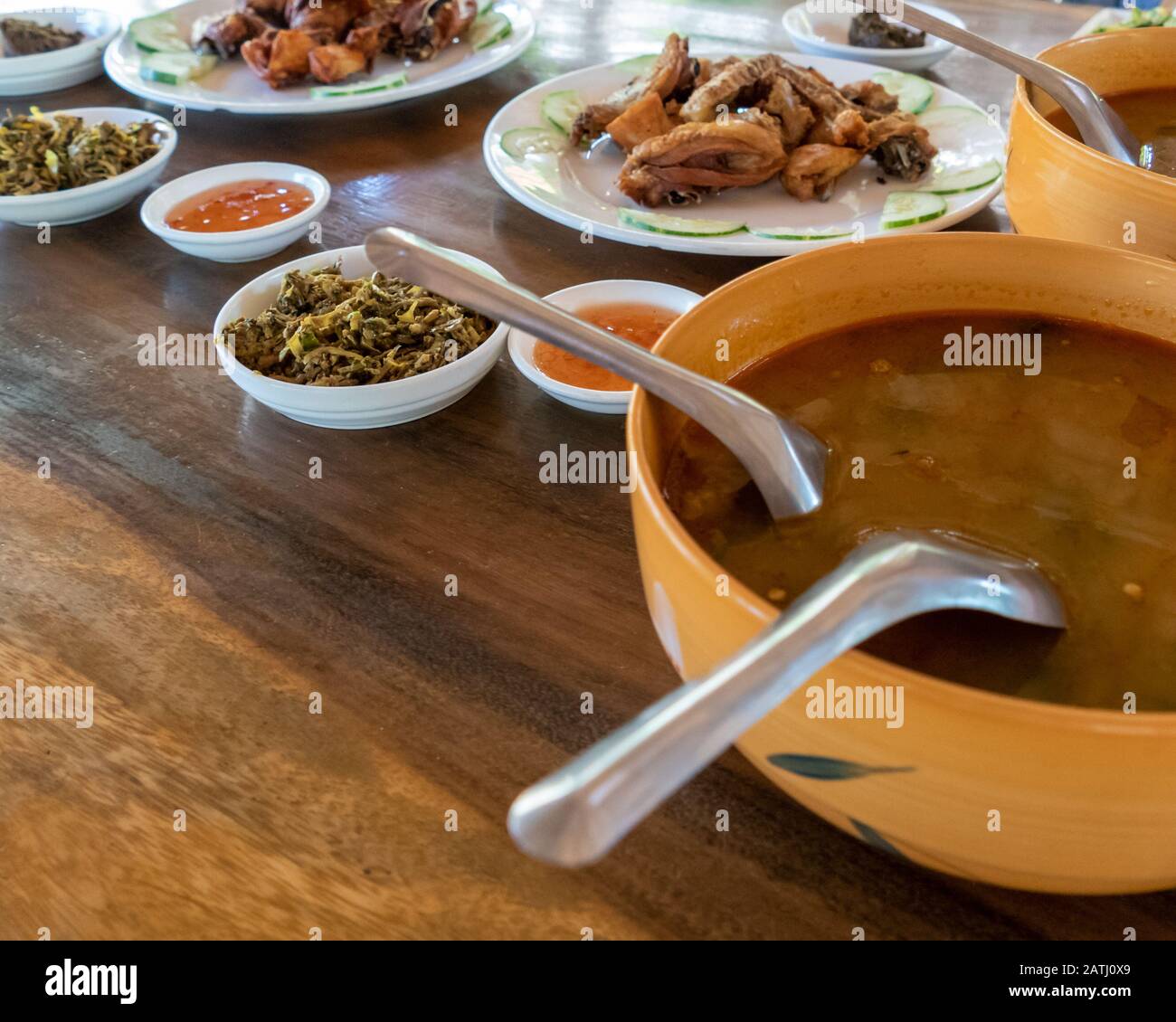 Selection of burmese dishes in rural Myanmar with skinny chicken and ...