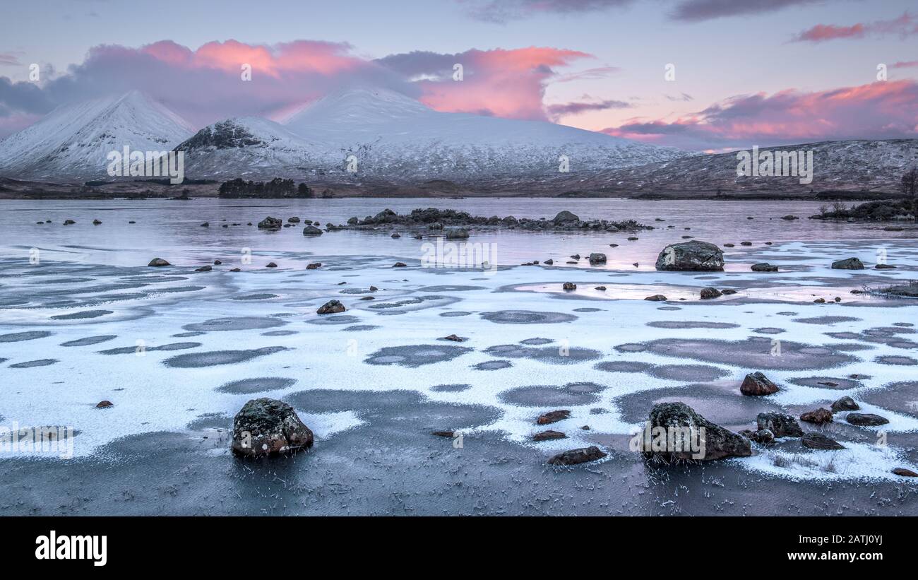 Sunrise over a frozen Lochan na h-achlaise on Rannoch Moor near the ...
