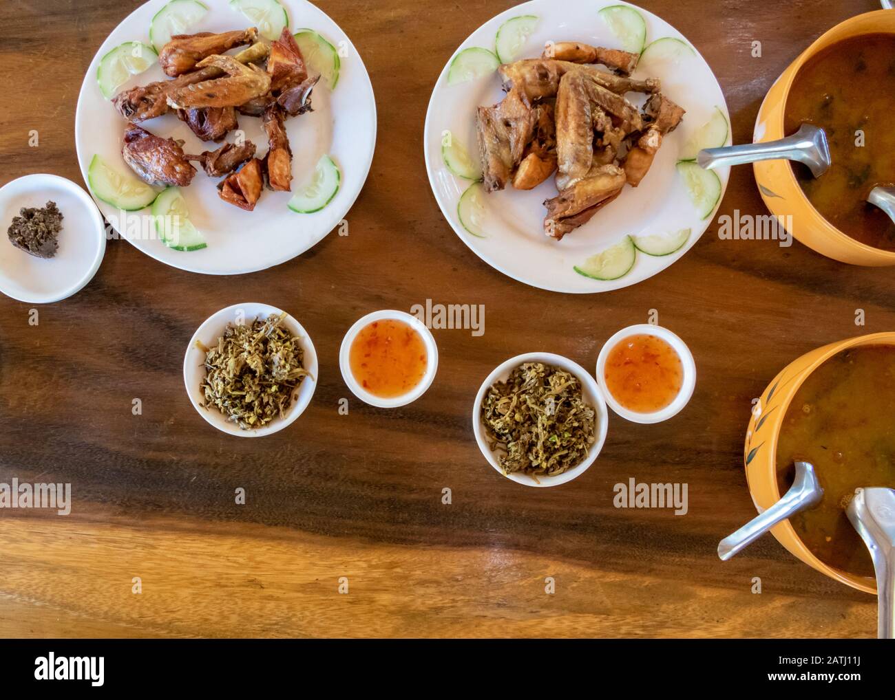 Selection of burmese dishes in rural Myanmar with skinny chicken and ...