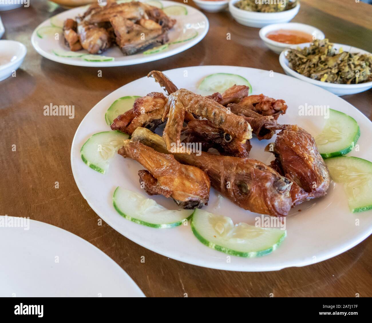 Selection of burmese dishes in rural Myanmar with skinny chicken and ...