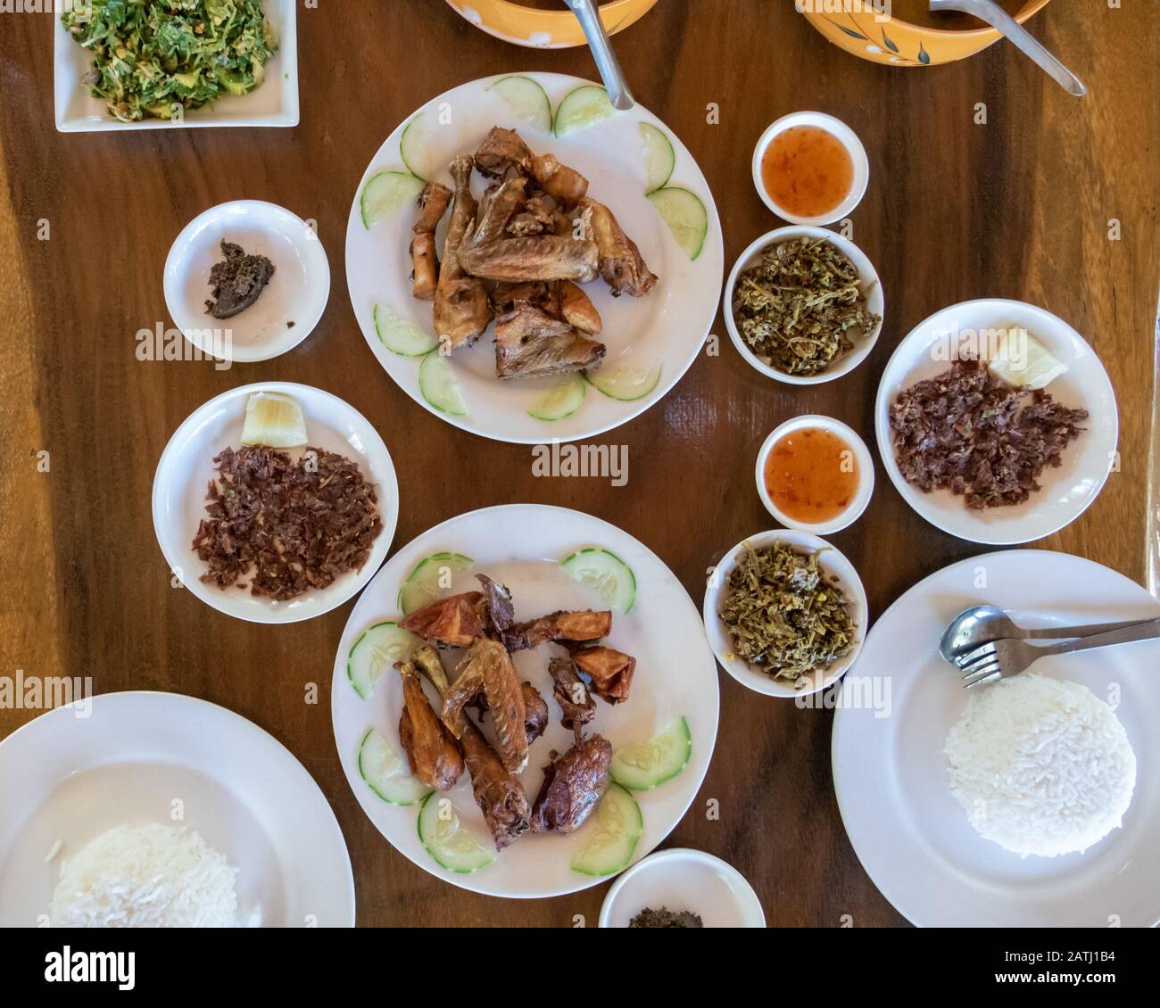 Selection of burmese dishes in rural Myanmar with skinny chicken and ...