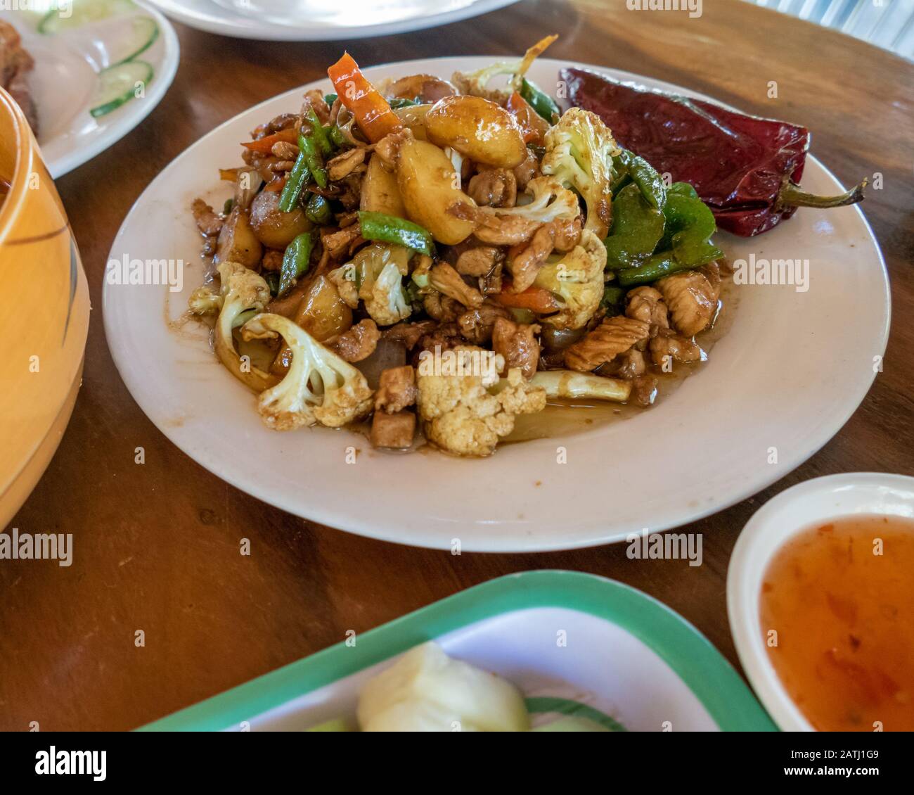 Selection of burmese dishes in rural Myanmar with skinny chicken and ...