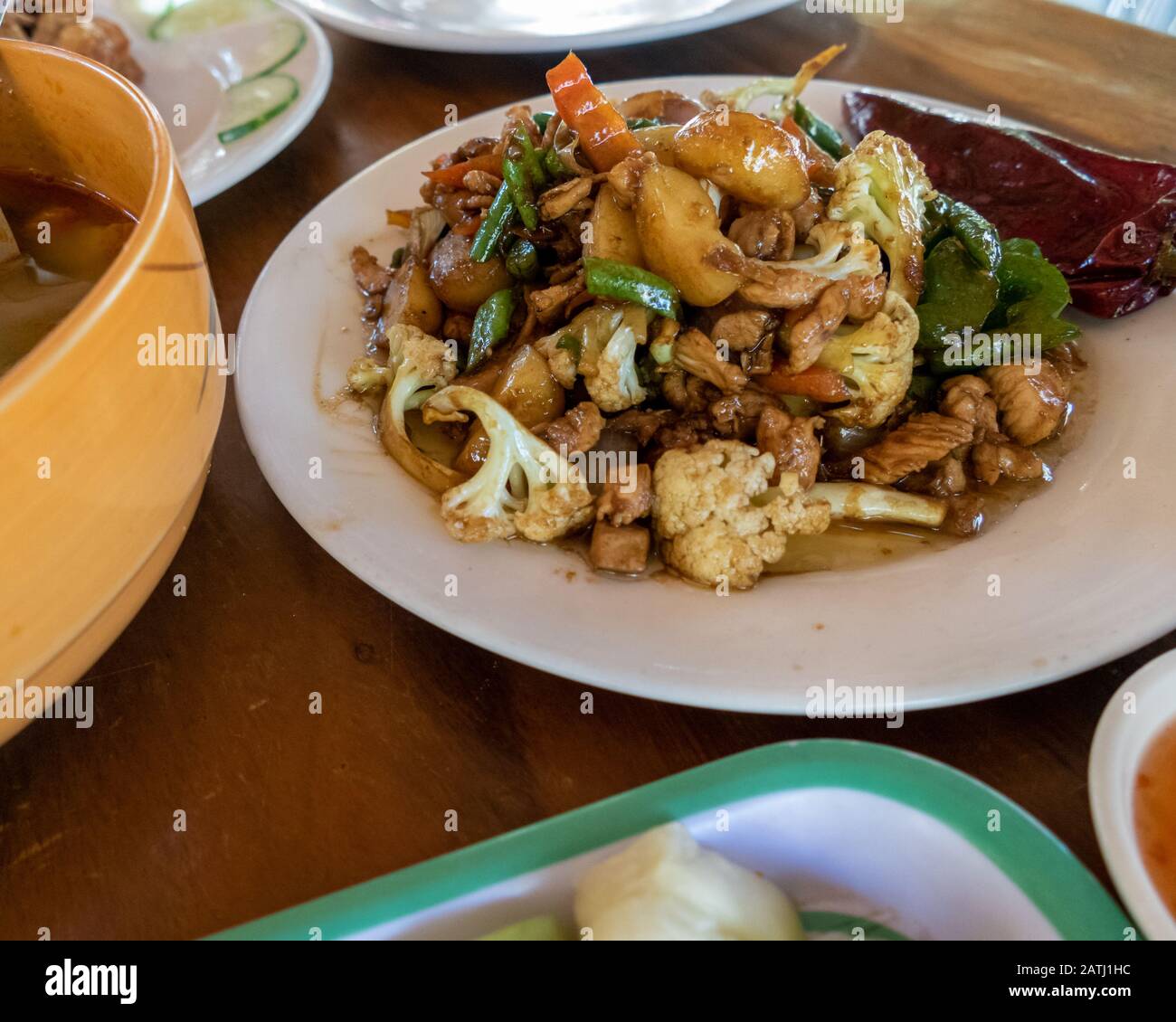 Selection of burmese dishes in rural Myanmar with skinny chicken and ...