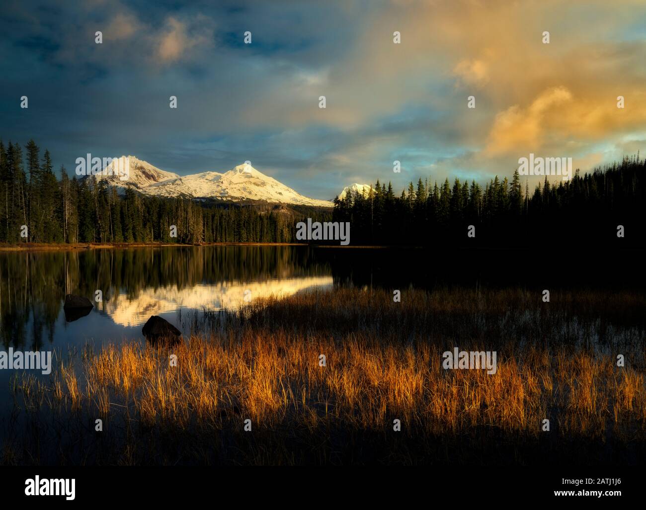 South and Middle Sister Mountains reflected in Scott Lake. Three ...