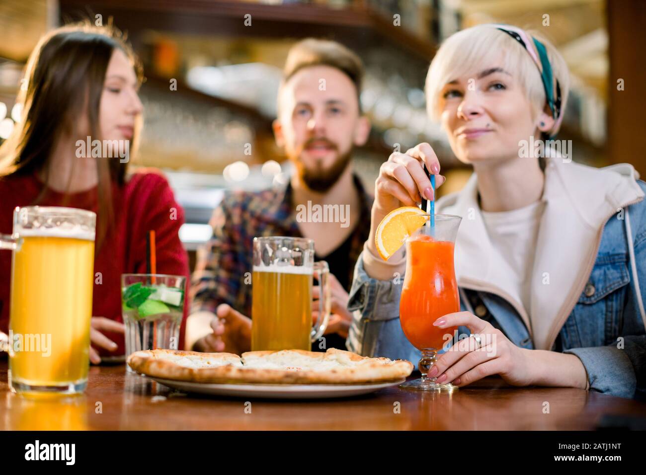 Smiling Friends Eating Pizza And Drinking Juice Laughing And Having