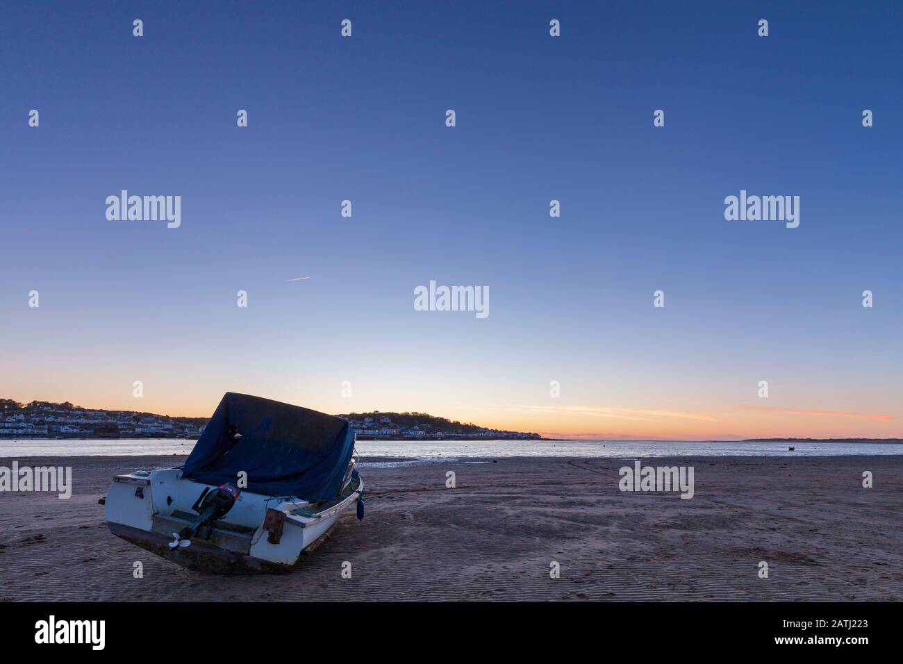 A stunning sunset scene at Instow beach, North Devon. boats are on the ...
