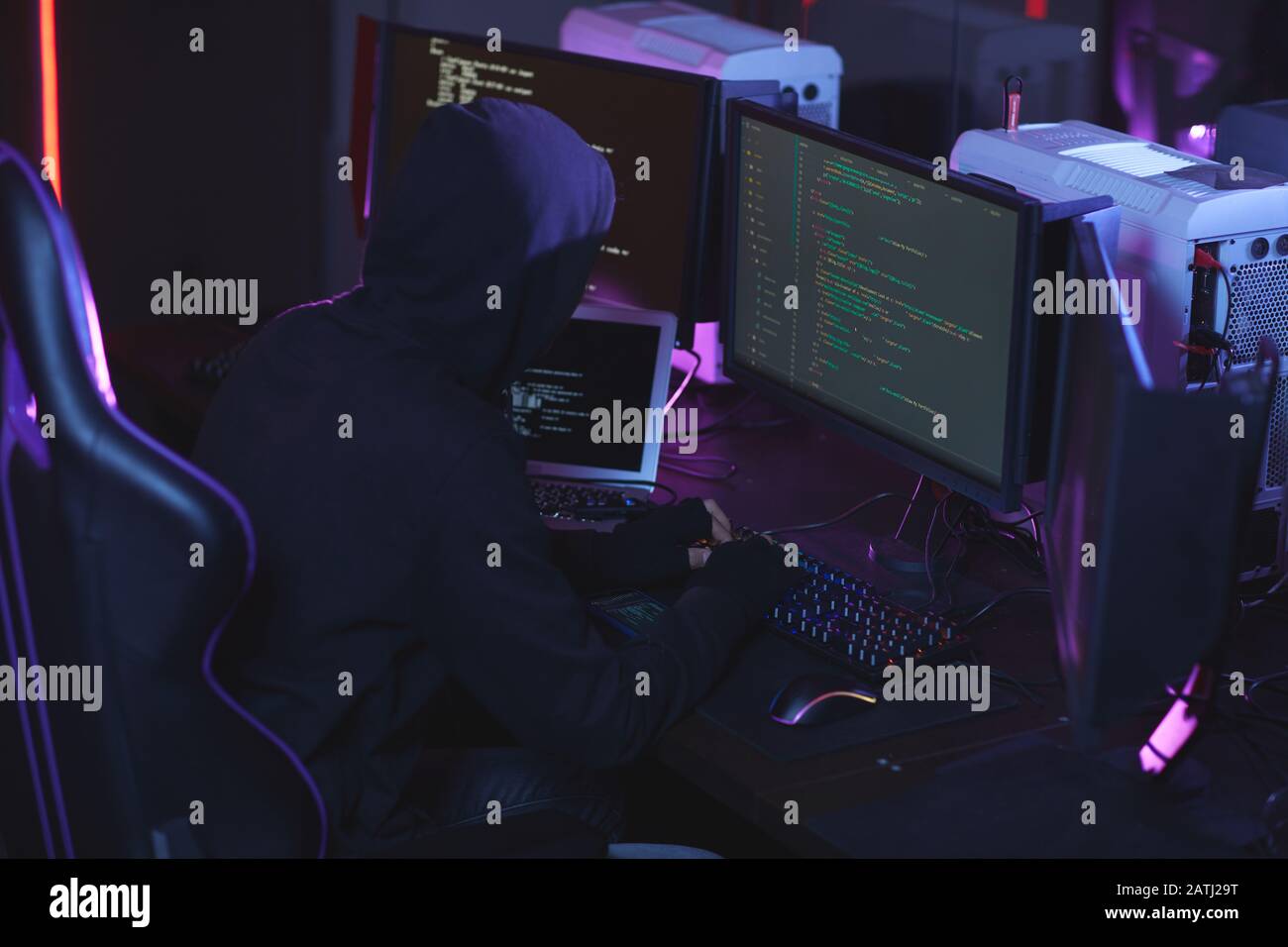 High angle view at unrecognizable cyber security hacker wearing hood ...