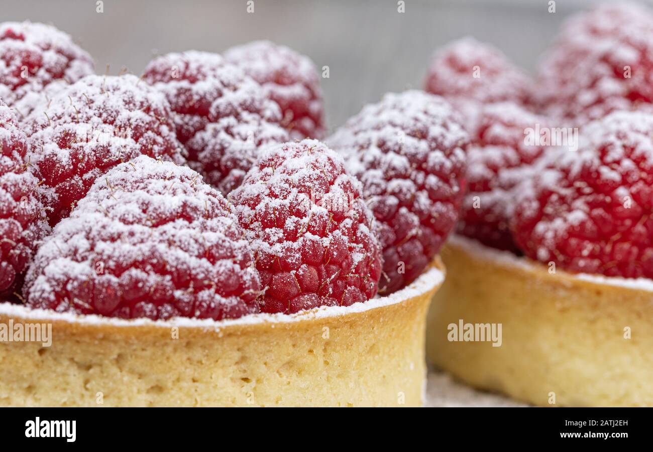 Delicious raspberry mini tarts on wooden background. Food photography ...