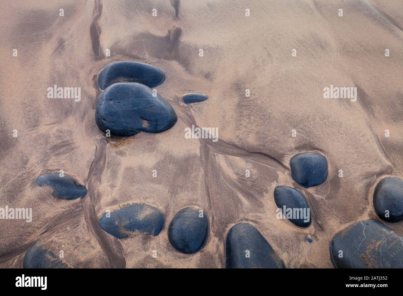 Pebble rocks in the sand background hi-res stock photography and images ...