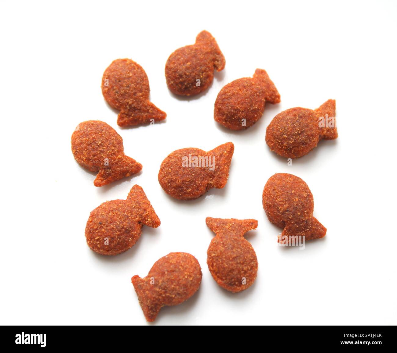 Cats dry food - fish shapes on white background Stock Photo - Alamy