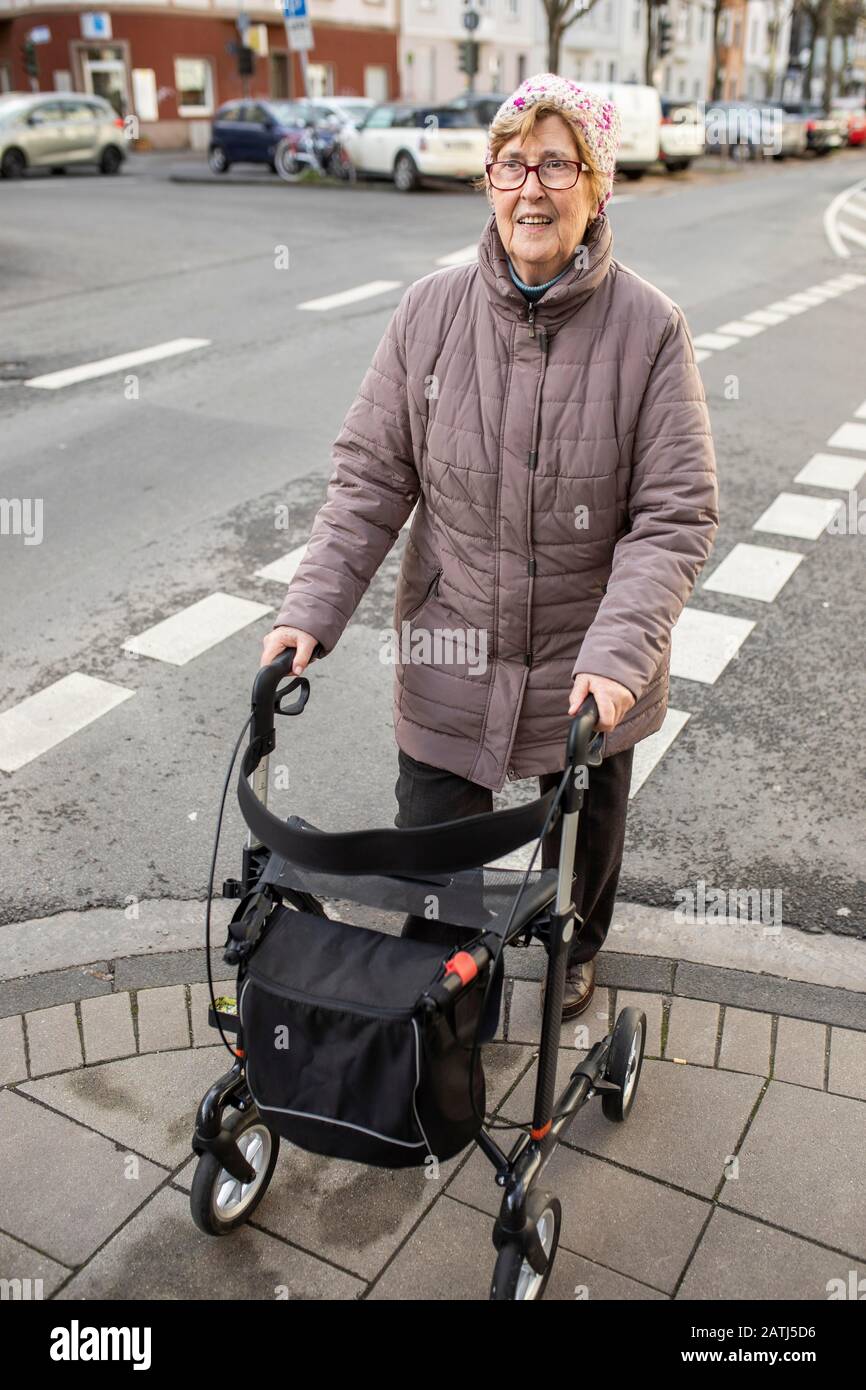 Senior citizen with rollator crosses a street in the city, Cologne ...
