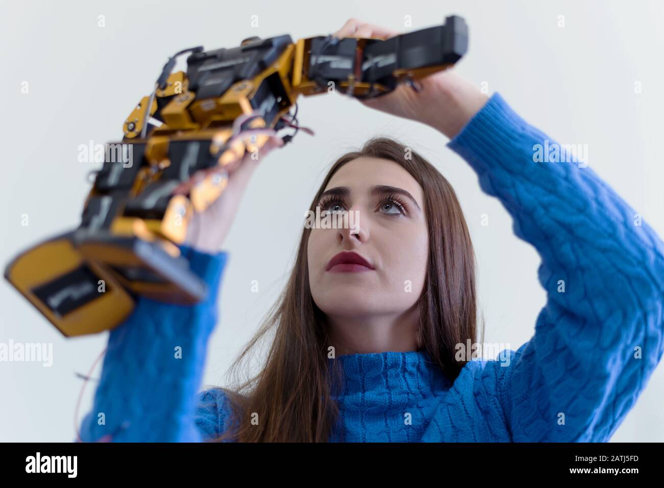 Scientists engineers designing small human robot, setting artificial intelligence humanoid robot ...