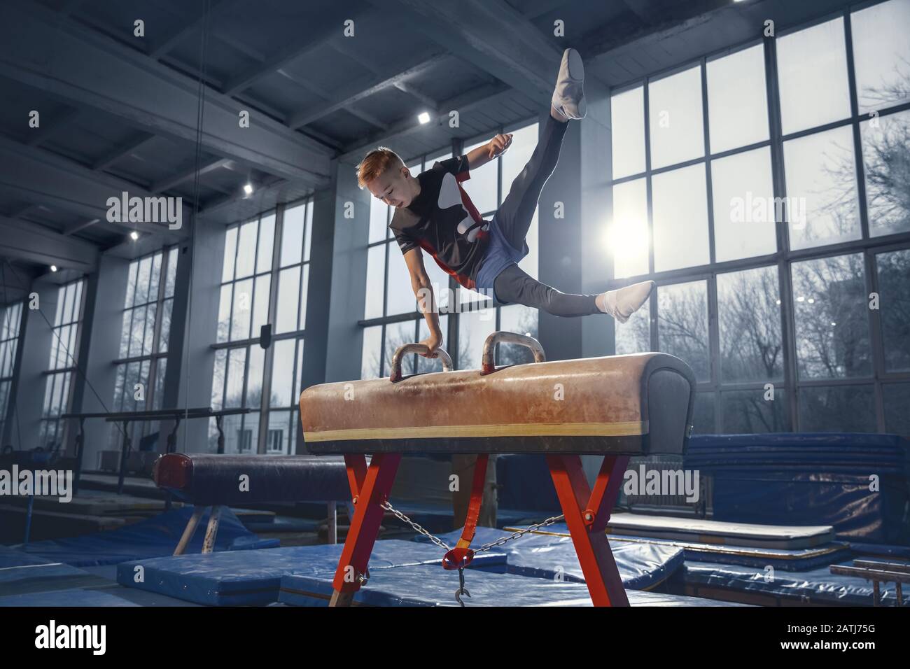 Little male gymnast training in gym, flexible and active. Caucasian fit ...