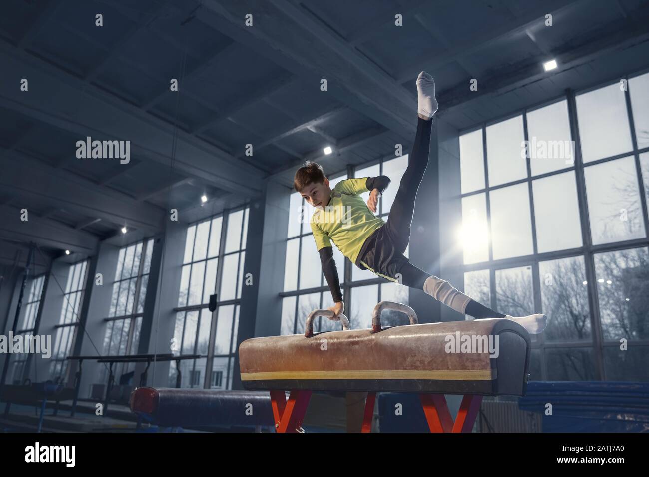 Little male gymnast training in gym, flexible and active. Caucasian fit ...