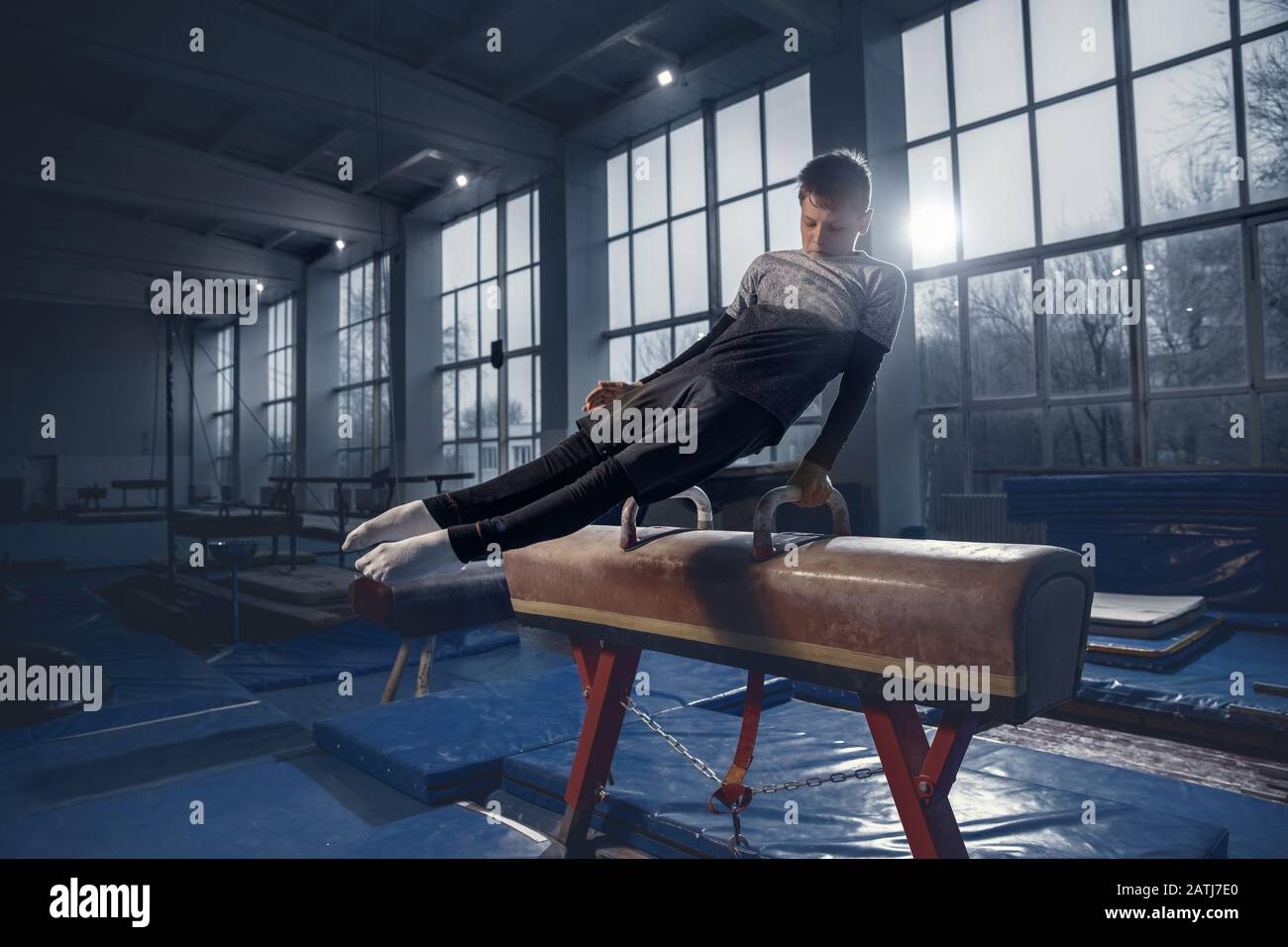 Little male gymnast training in gym, flexible and active. Caucasian fit ...
