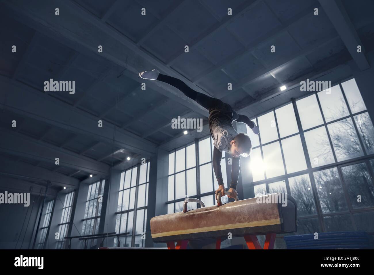 Little male gymnast training in gym, flexible and active. Caucasian fit ...