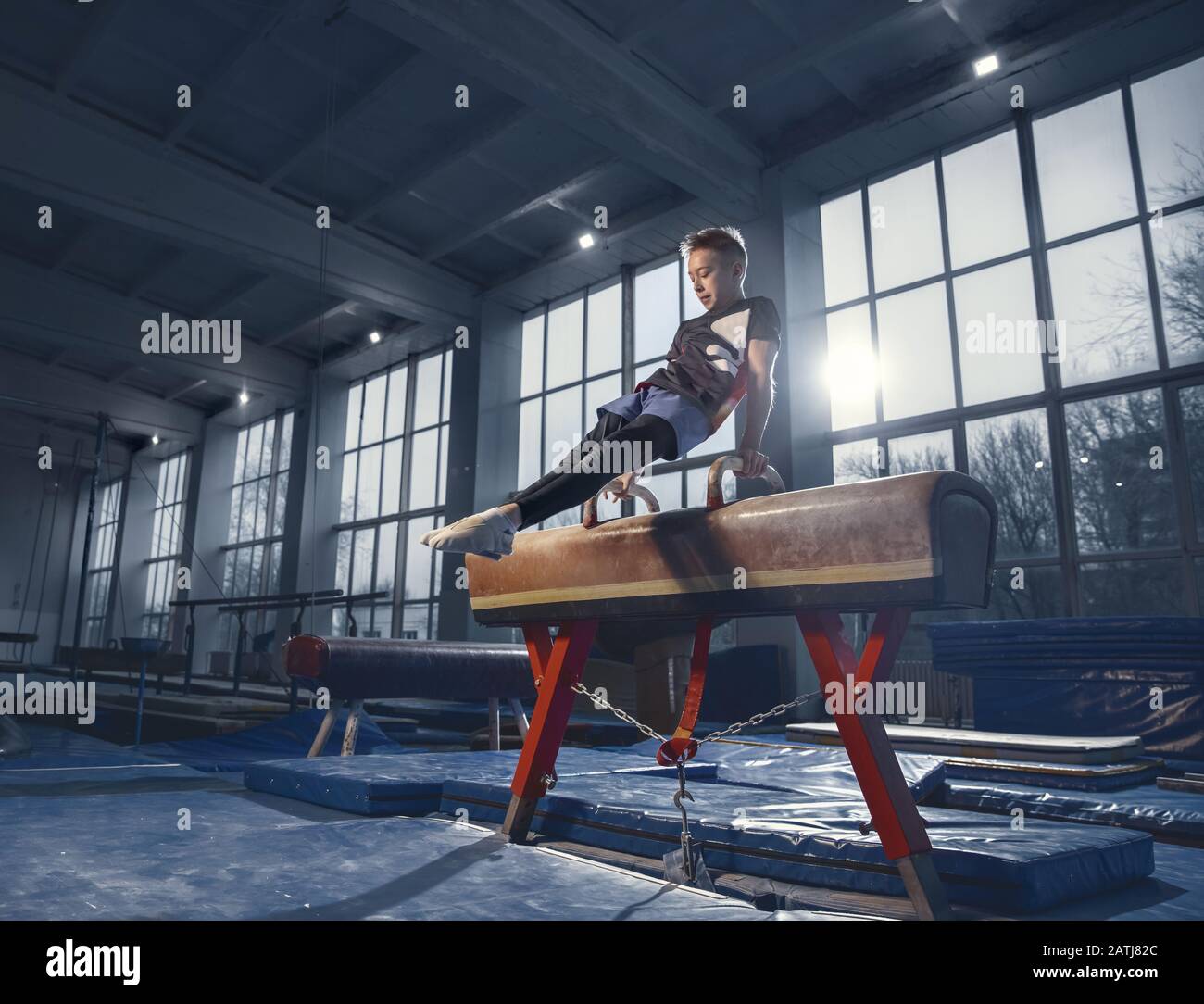 Little male gymnast training in gym, flexible and active. Caucasian fit ...