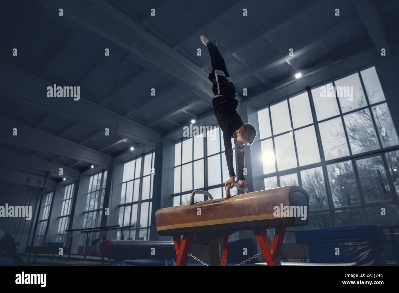 Little male gymnast training in gym, flexible and active. Caucasian fit ...