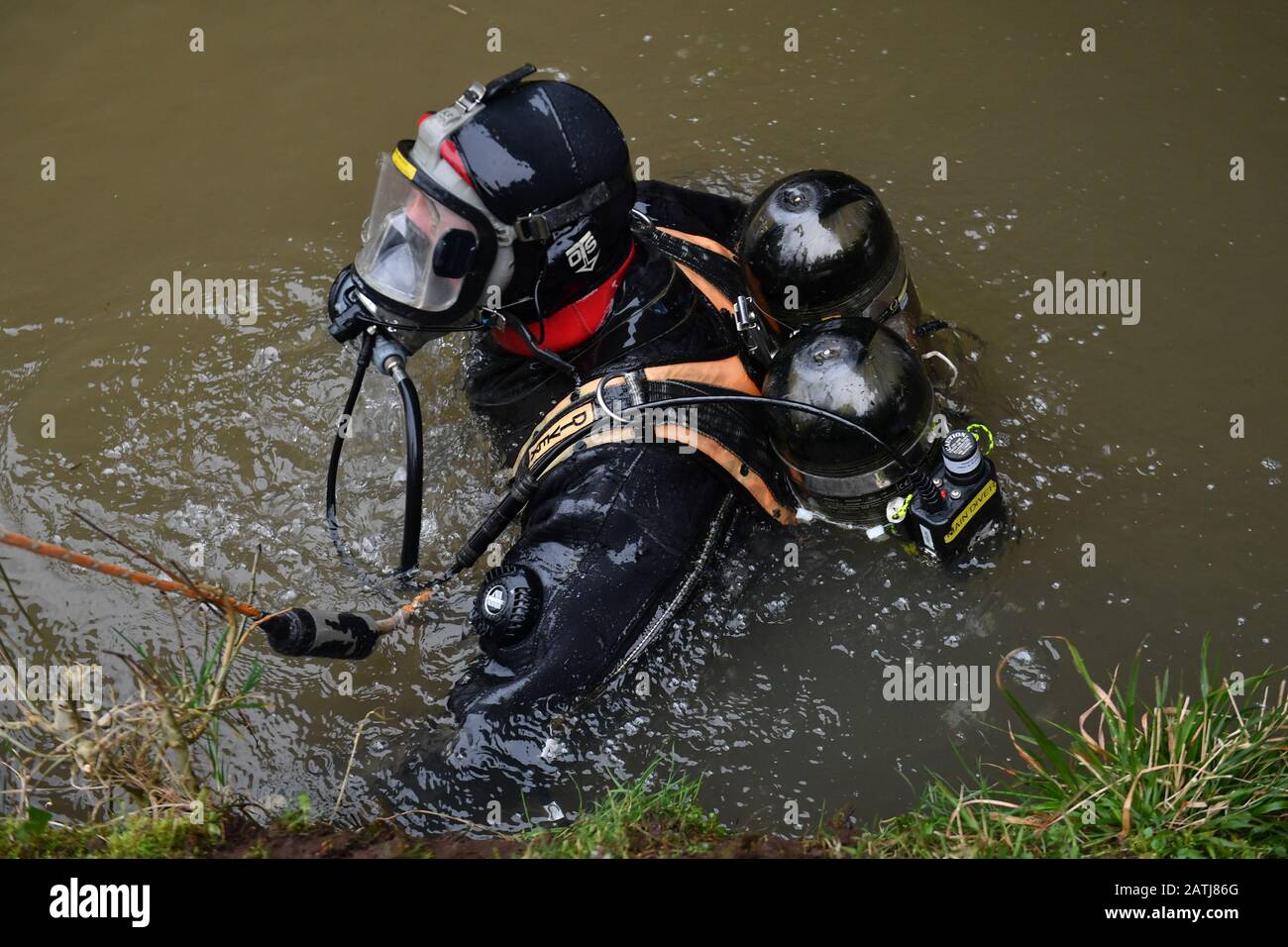 A police diver enters a canal near Rugby, Warwickshire, after ...