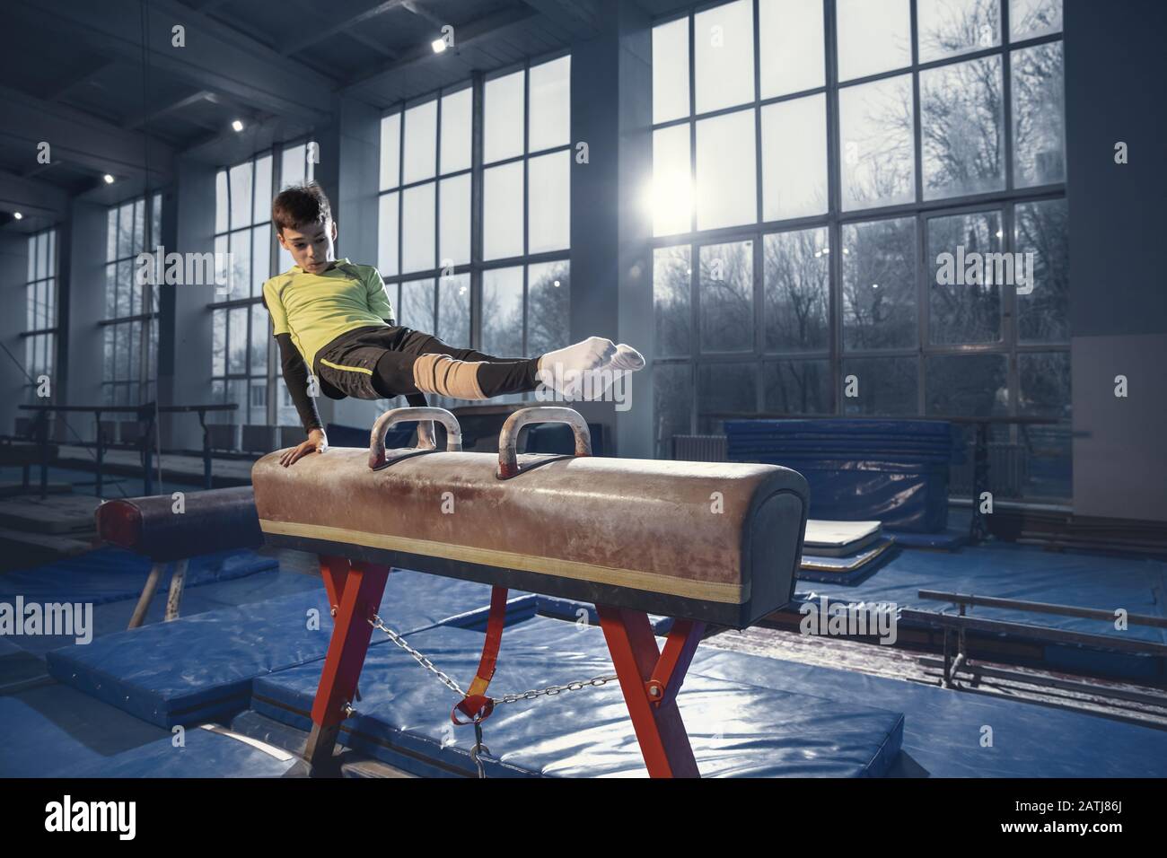 Little male gymnast training in gym, flexible and active. Caucasian fit ...