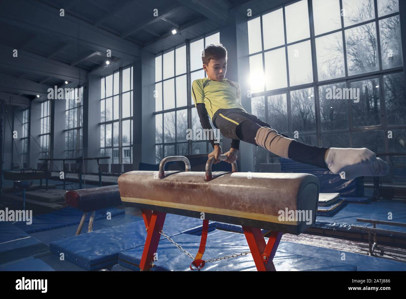 Little male gymnast training in gym, flexible and active. Caucasian fit ...