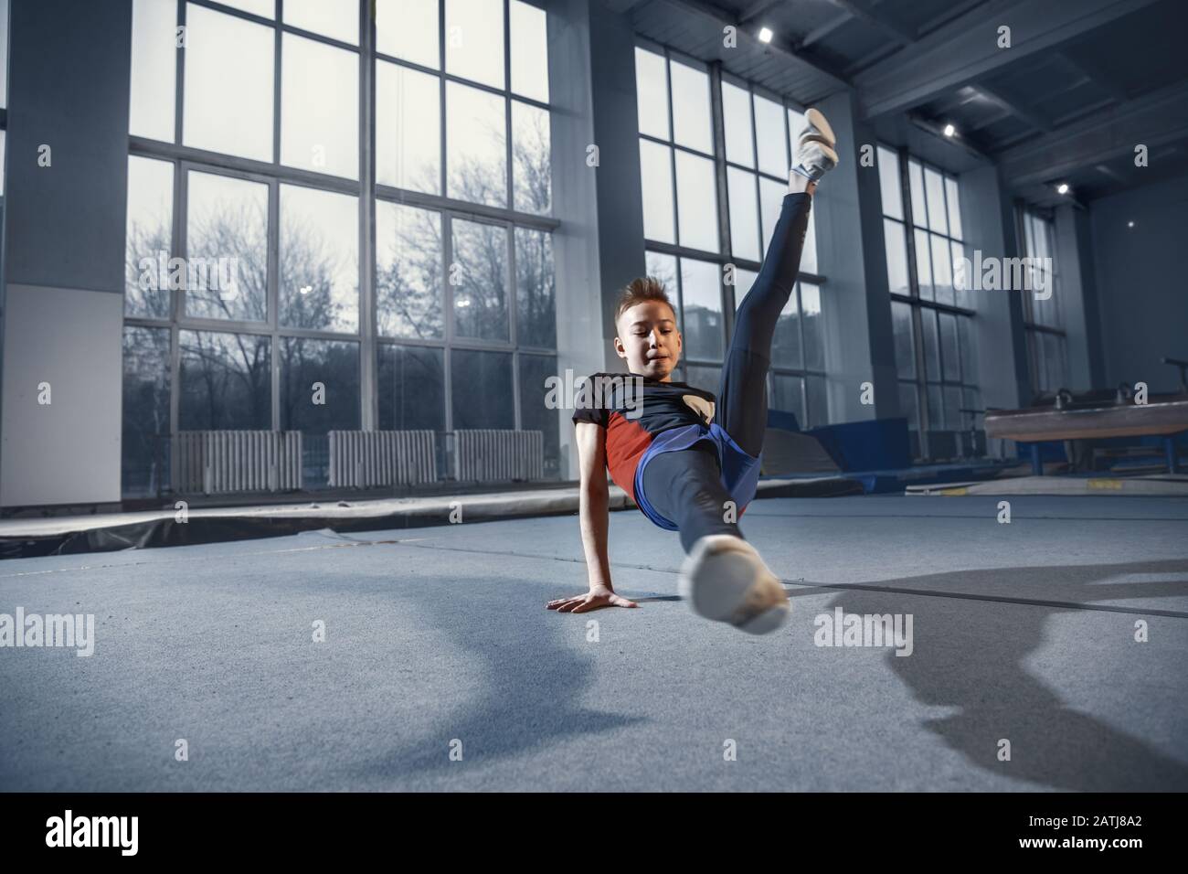 Little male gymnast training in gym, flexible and active. Caucasian fit ...