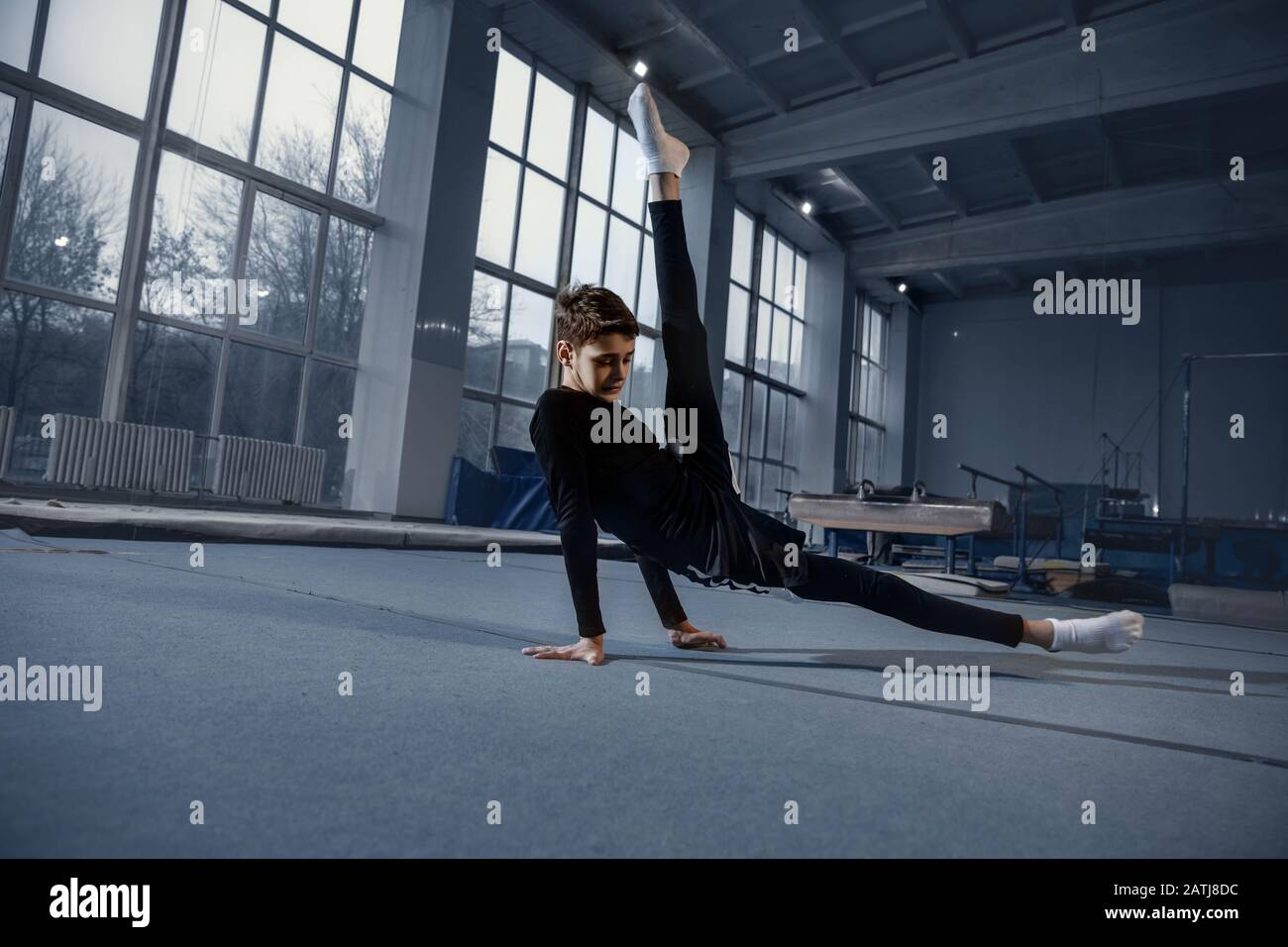 Little male gymnast training in gym, flexible and active. Caucasian fit ...