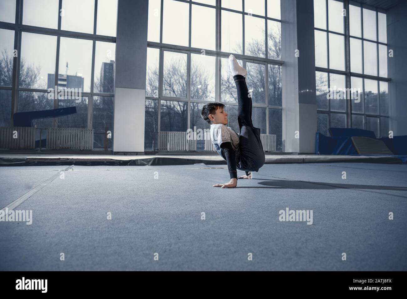 Little male gymnast training in gym, flexible and active. Caucasian fit ...