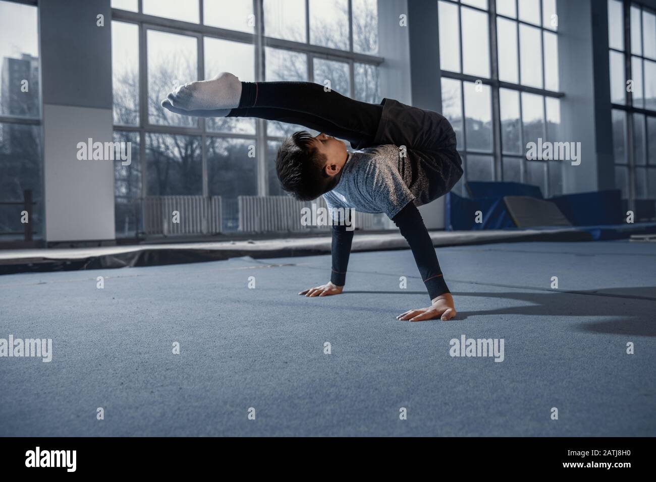 Little male gymnast training in gym, flexible and active. Caucasian fit ...