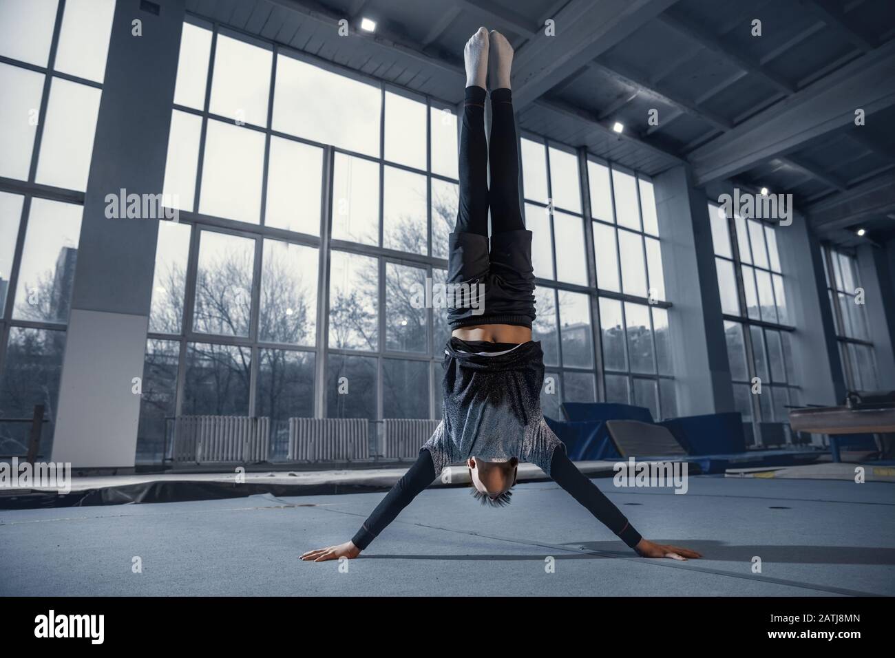 Little male gymnast training in gym, flexible and active. Caucasian fit ...