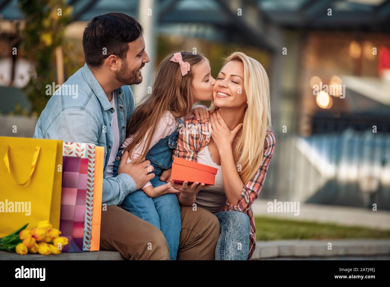 Family having fun outdoor after shopping.Family with daughter doing ...