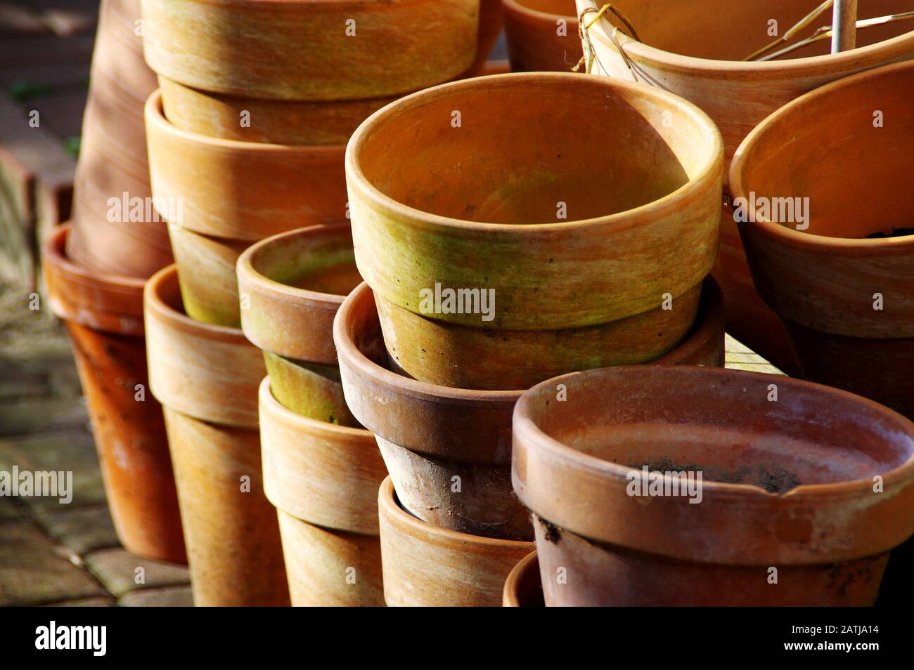Orange clay pots in the sun. Preparation for spring home gardening ...