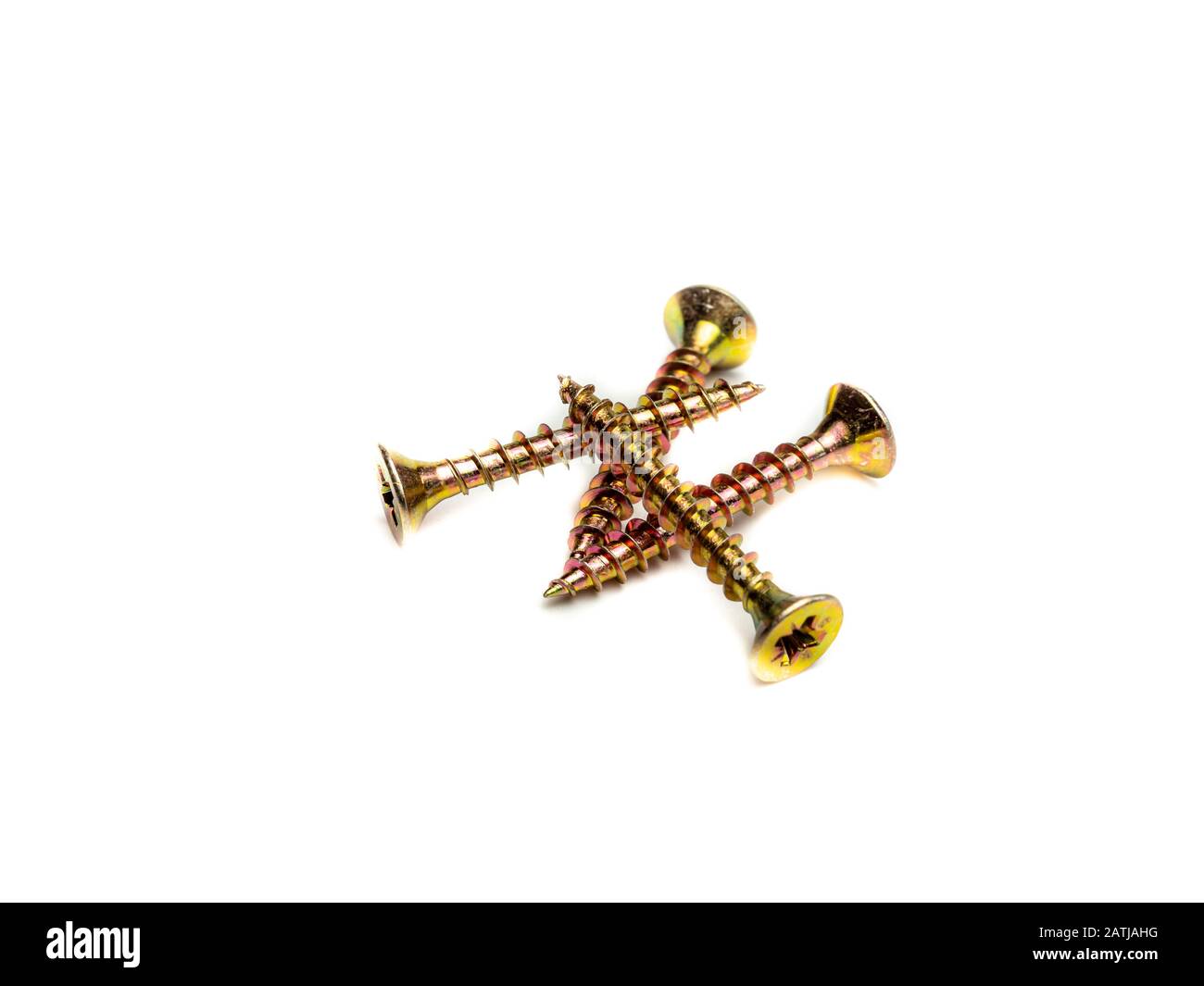 Golden little screws isolated white background Stock Photo - Alamy