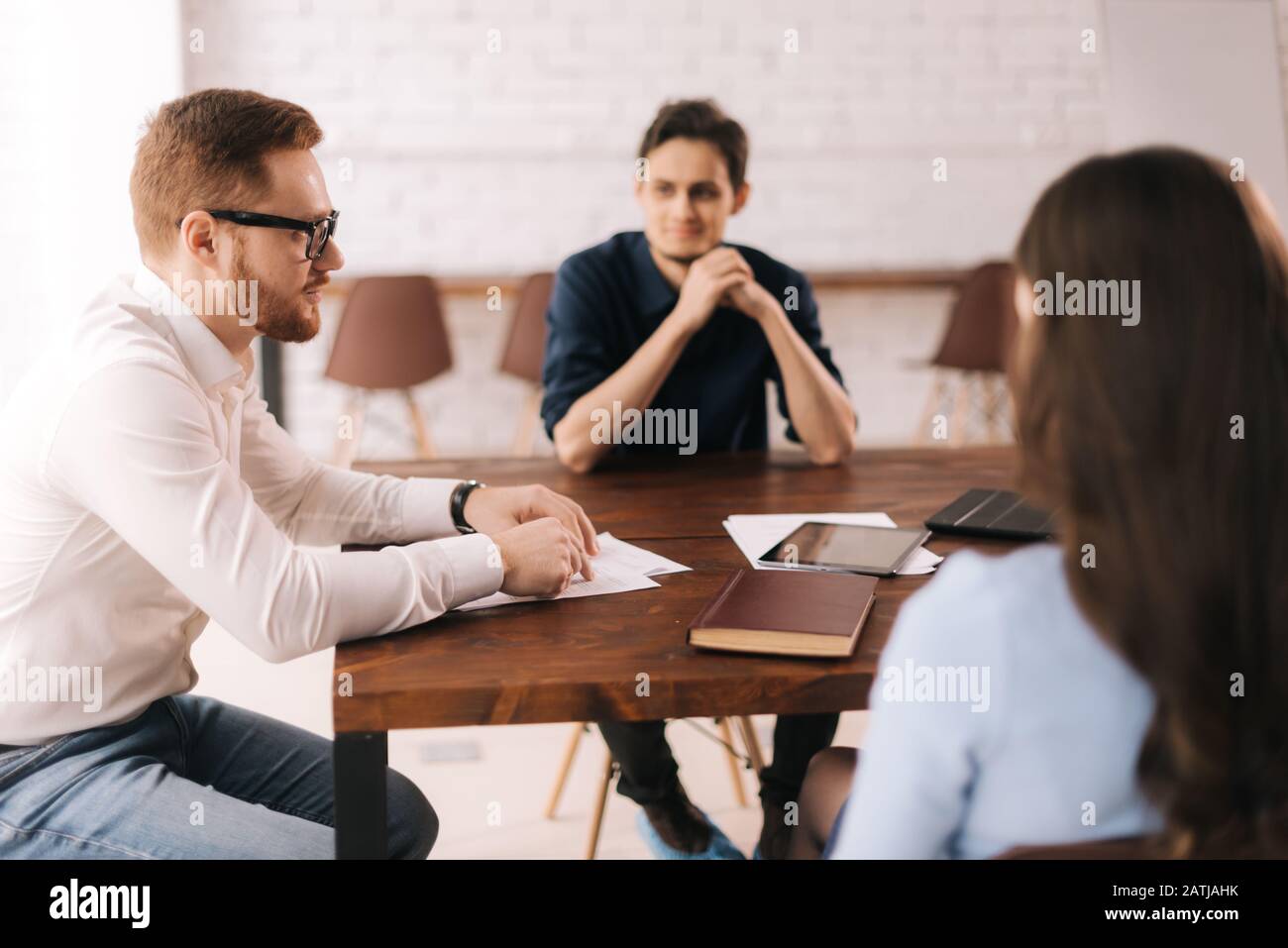 Young business man leader sharing ideas his colleagues in modern office ...